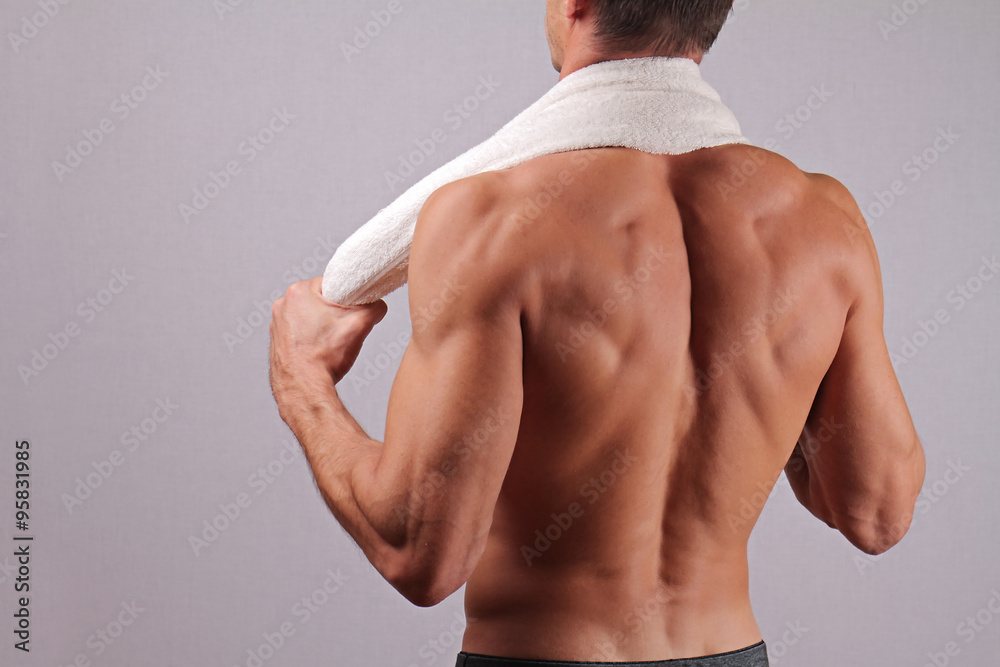 Back view of strong muscular male body, closeup of fitness man with a ...