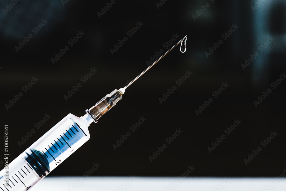 Syringe with pouring medicine close up Stock Photo | Adobe Stock