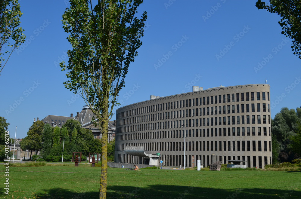 Green park with tall trees at the university of Brussels, with modern ...
