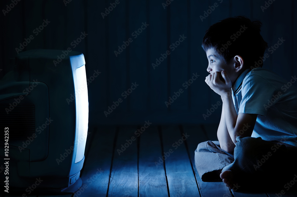 Boy watching TV at night Stock Photo | Adobe Stock