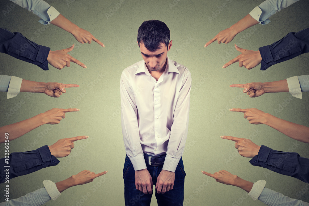 accusation of guilty guy. Sad upset man looking down many fingers ...