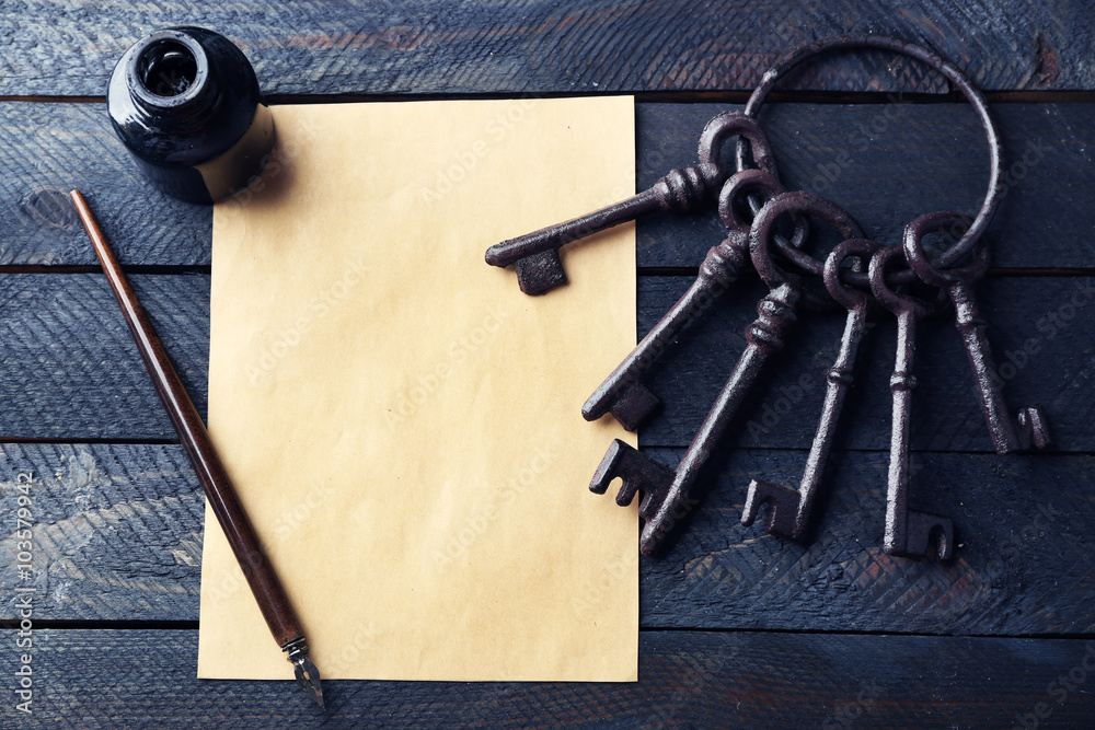 Bunch of old keys with paper, ink and pen on dark wooden background ...