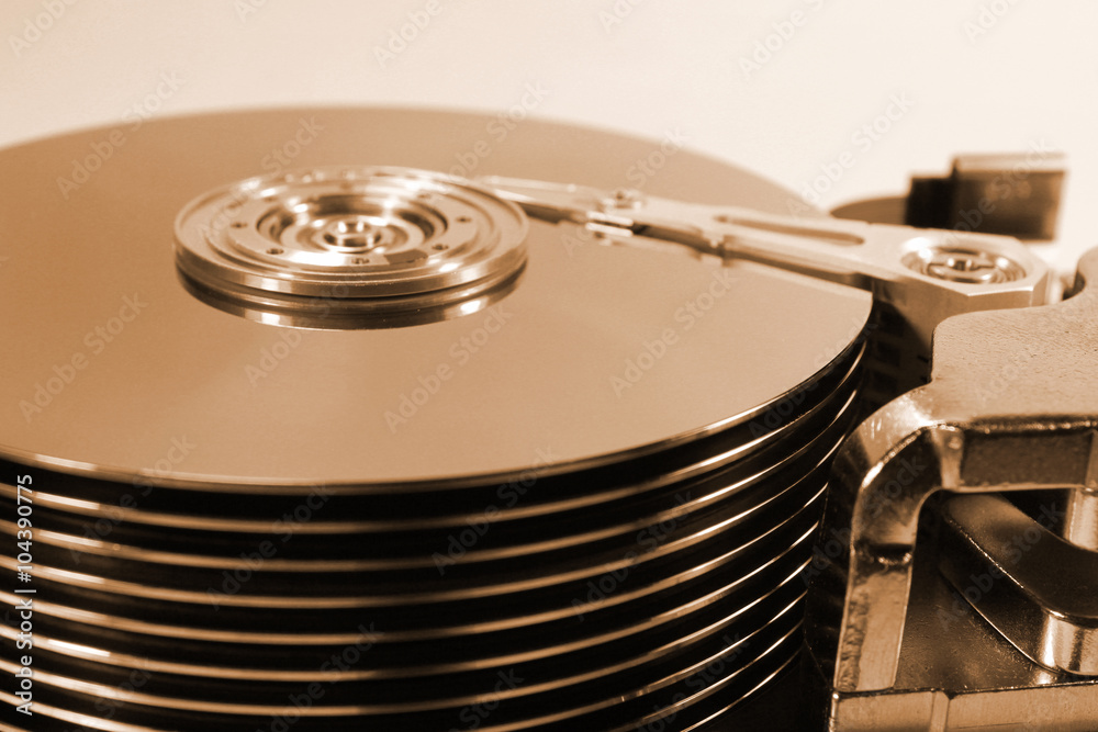 Old retro open hard disk drive. Thick stack of ten platters and ...