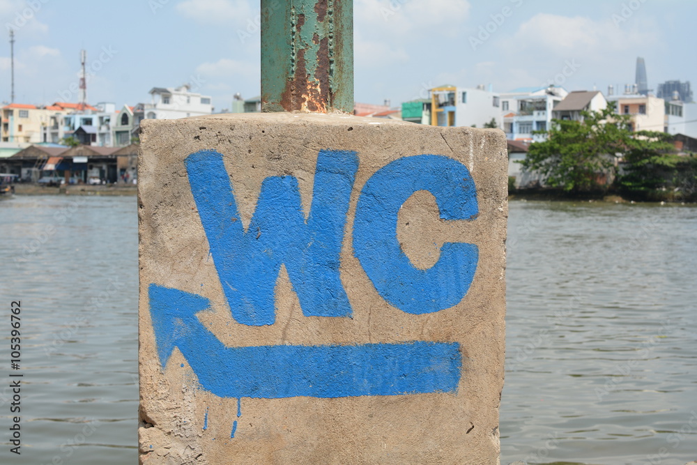 Bizarre Toilet WC Sign Painted on a Square Cement Brick with an Arrow ...