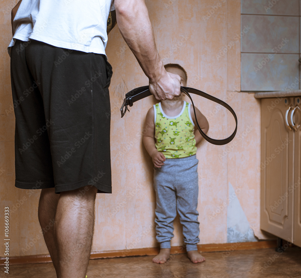 Angry father with belt and scared child Stock Photo | Adobe Stock