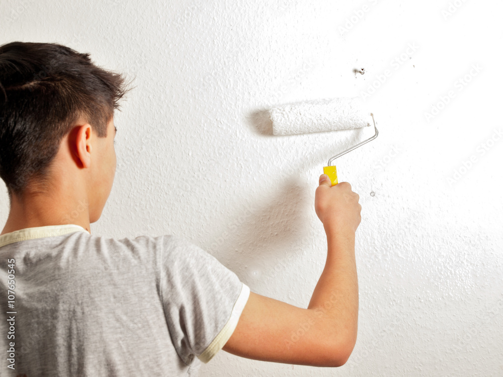 teenage boy painting the walls Stock Photo | Adobe Stock