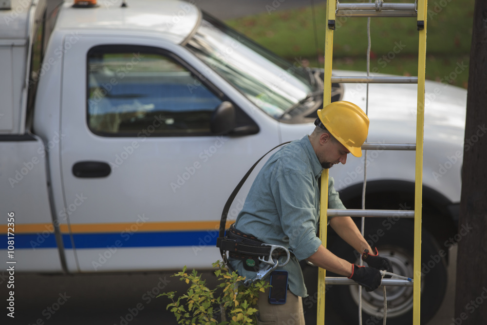 Caucasian worker raising ladder outdoors Stock Photo | Adobe Stock