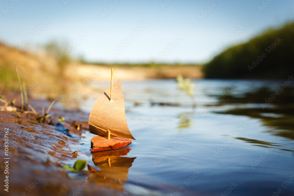 DIY Bark Toy Boat on river at sunset Stock Photo | Adobe Stock