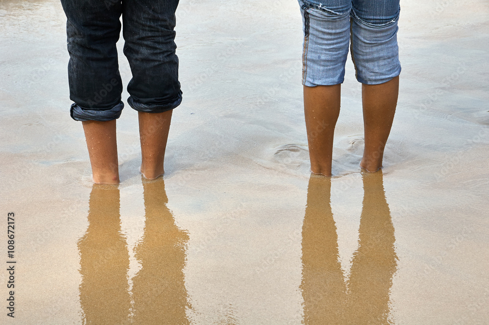 Bare feet buried in the sand upto the ankles on a beach Stock Photo ...