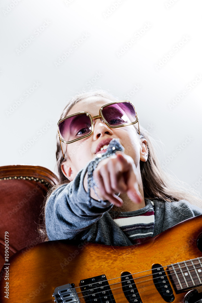 little girl playing as a guitar hero rockstar Stock Photo | Adobe Stock