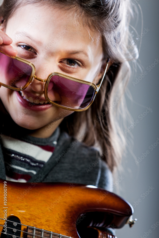 little girl playing as a guitar hero rockstar Stock Photo | Adobe Stock