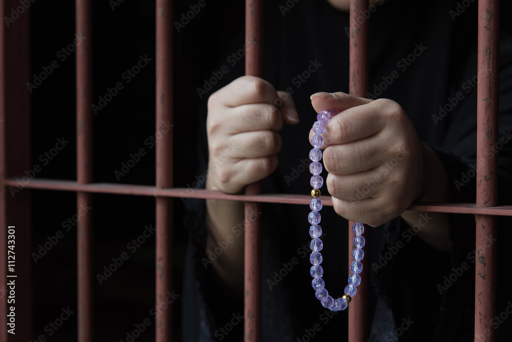 Muslim woman hand in jail Stock Photo | Adobe Stock