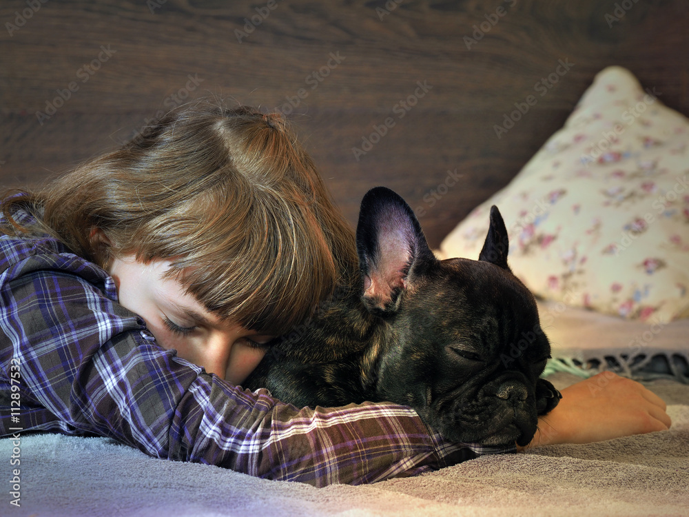 Overnight, the girl sleeping in an embrace with a dog. Evening light ...