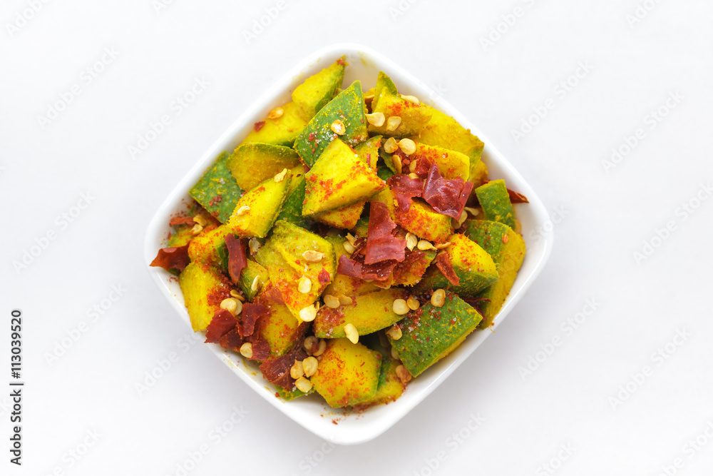Organic sliced Indian Mango (Mangifera indica), seasoned with turmeric ...