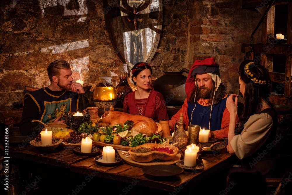 Medieval people eat and drink in ancient castle kitchen interior. Stock ...