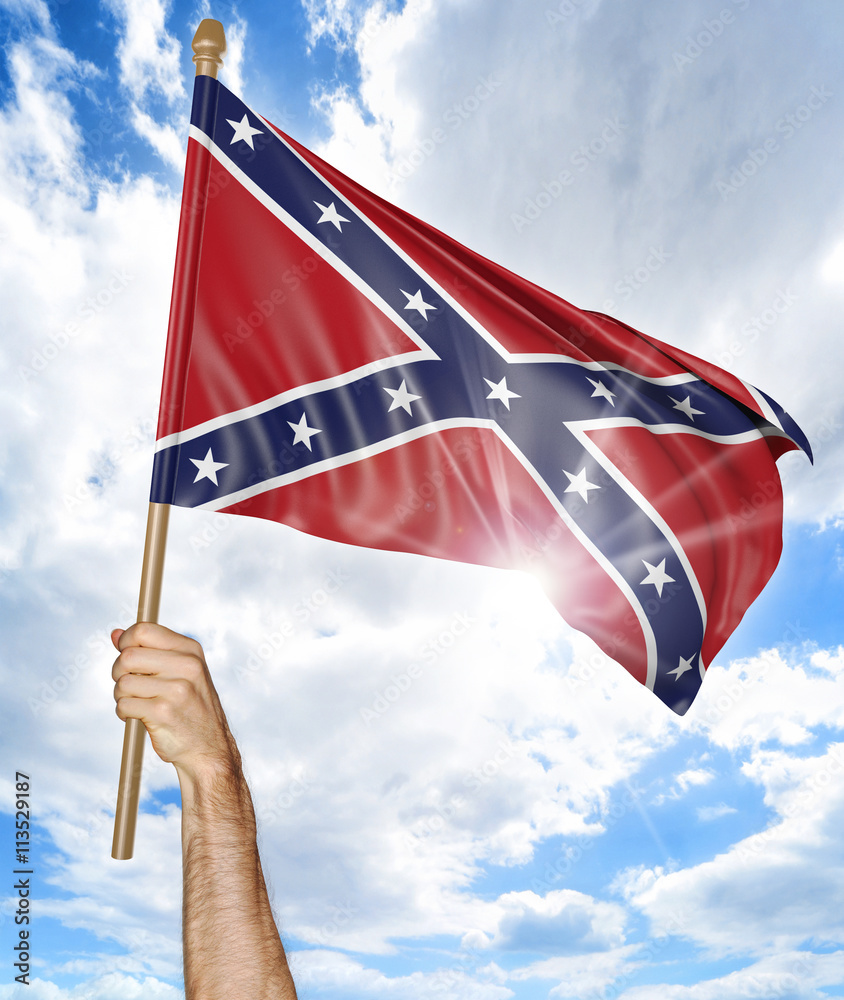 Person's hand holding the Confederate States flag and waving it in the ...