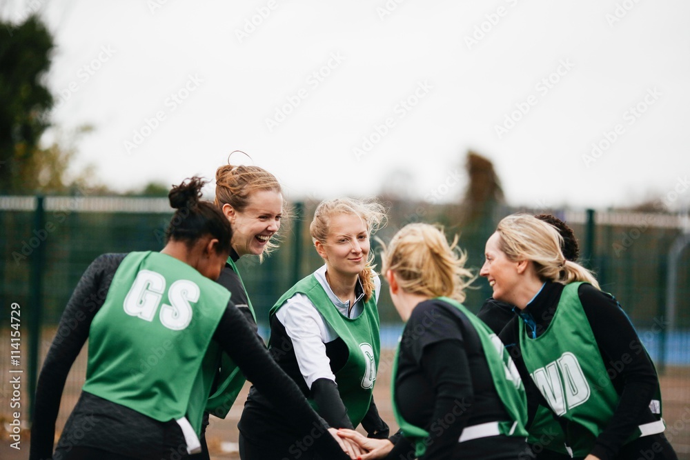 Female netball team shaking hands on netball court Stock Photo | Adobe ...