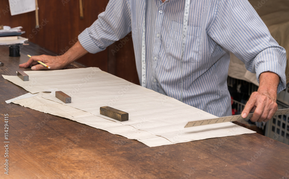 Production process of suit tailoring. drawing the outline of parts of a ...