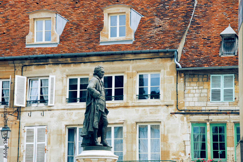Foto de Stock Street scene in the old French village Langres. Statue of ...
