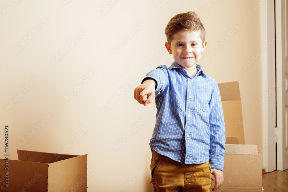 little cute boy in empty room, remoove to new house. home alone emong ...
