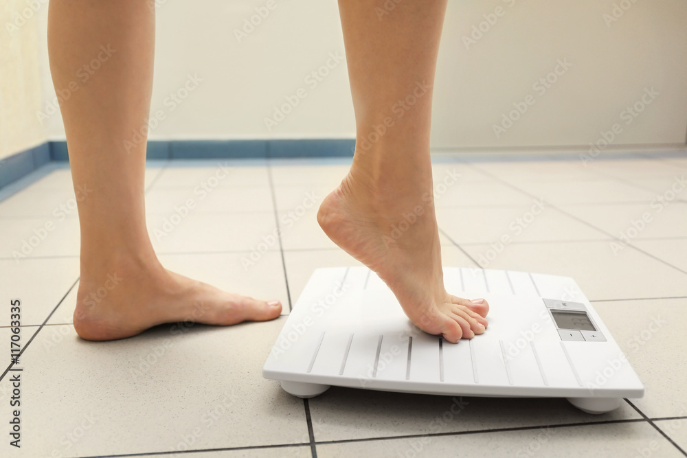 Female leg stepping on floor scales Stock Photo | Adobe Stock
