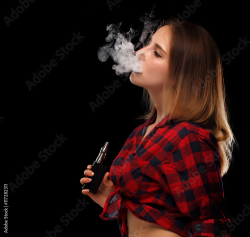 Young Beautiful Woman Smoking Vaping E Cigarette A Cloud Of Vapor