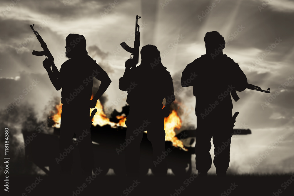 Silhouette of terrorist holding rifle against burning tank Stock Photo ...