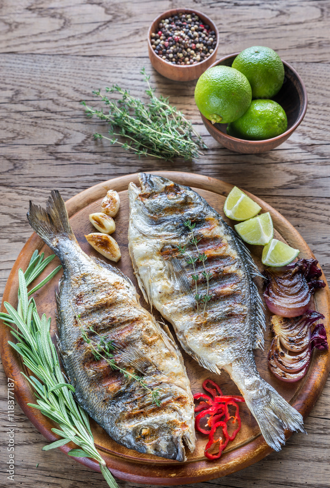 Grilled Dorade Royale Fish on the wooden board Stock Photo | Adobe Stock