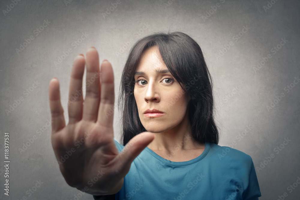 Fearful woman giving hand stop sign Stock Photo | Adobe Stock