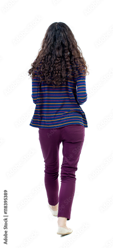 back view of walking curly woman. backside view of person. Rear view ...