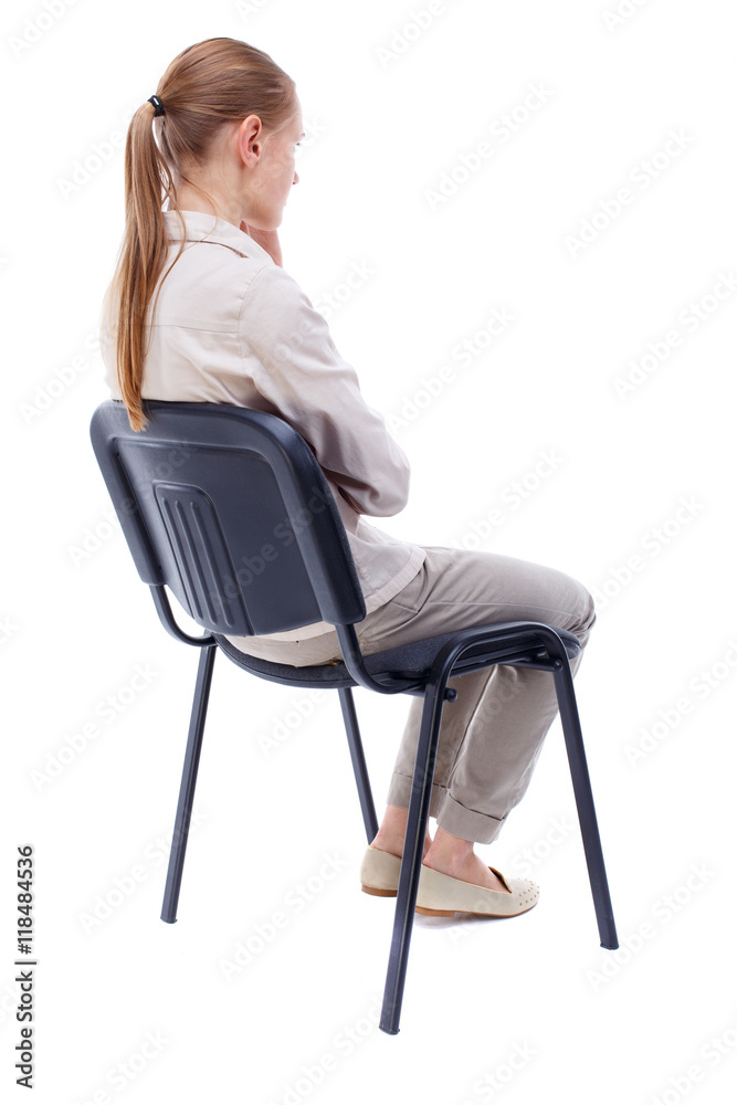 back view of young beautiful woman sitting on chair. girl watching ...
