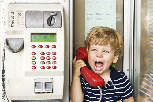 A little boy yelling into the phone. Kid screaming into the red ...