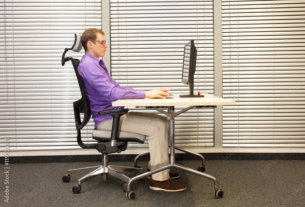 Foto correct sitting position at workstation. man on chair working with ...