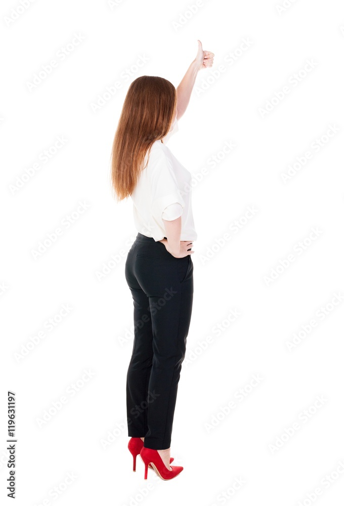 back view of standing young redhead business woman showing thumb up ...