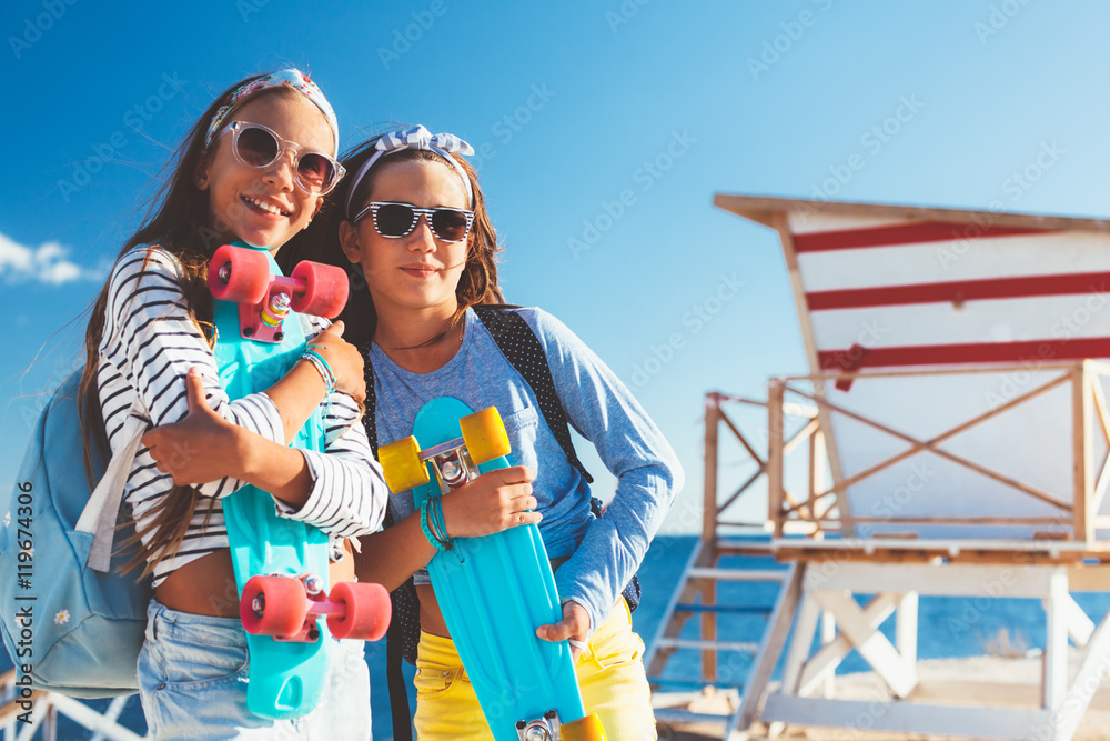 Two 10 years old children wearing cool clothing posing with colorful ...