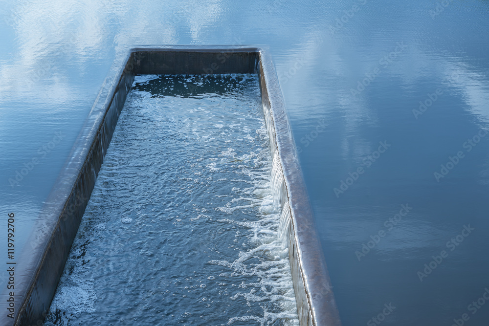 detail of a concrete weir (drowned weir) - river through with sky ...