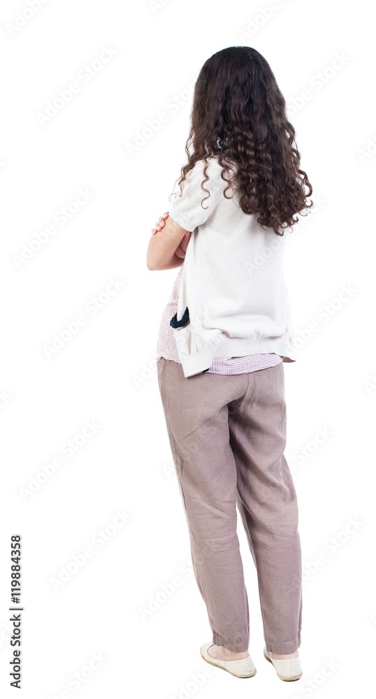 back view of standing young beautiful woman. girl watching. Rear view ...