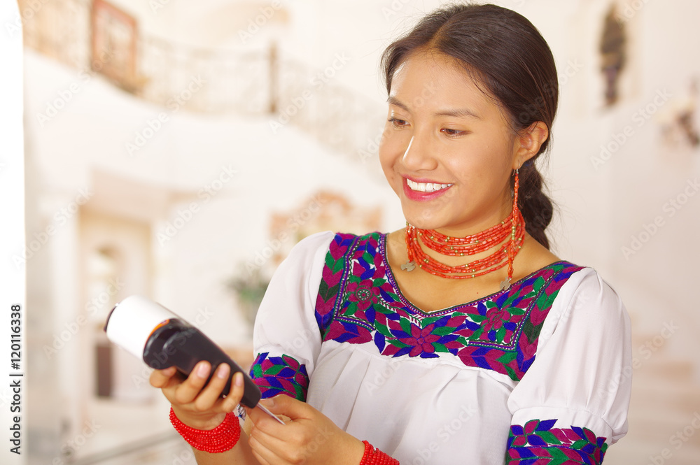 Young brunette wearing traditional native clothes working as hotel ...