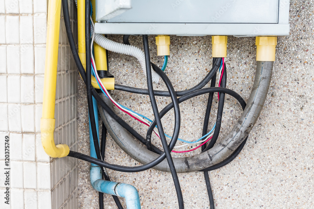 Too many Cable plugs in a socket on brick wall. Danger of using Stock ...