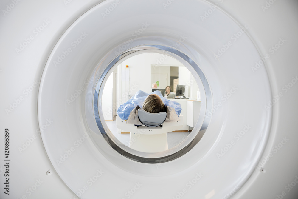 Woman Undergoing CT Scan While Doctor's Using Computers Stock Photo ...
