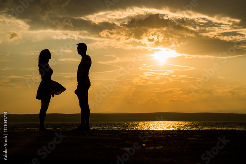 silhouette Romantic couple lovers standing facing each other at ...