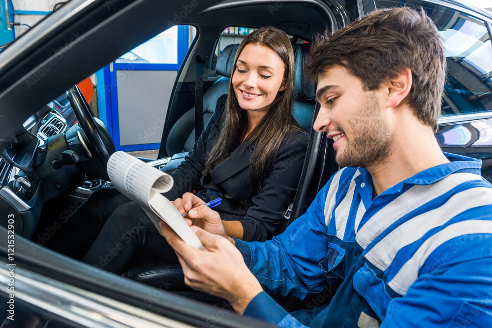 Car Mechanic With Customer Going Through Maintenance Checklist Stock ...