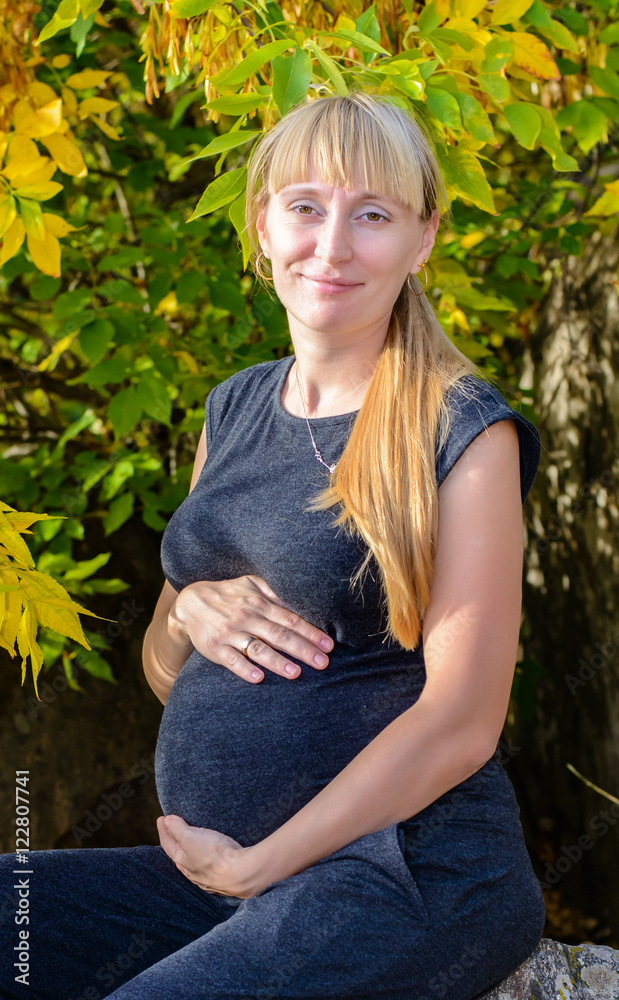 Heavily pregnant woman with a lovely smile Stock Photo | Adobe Stock