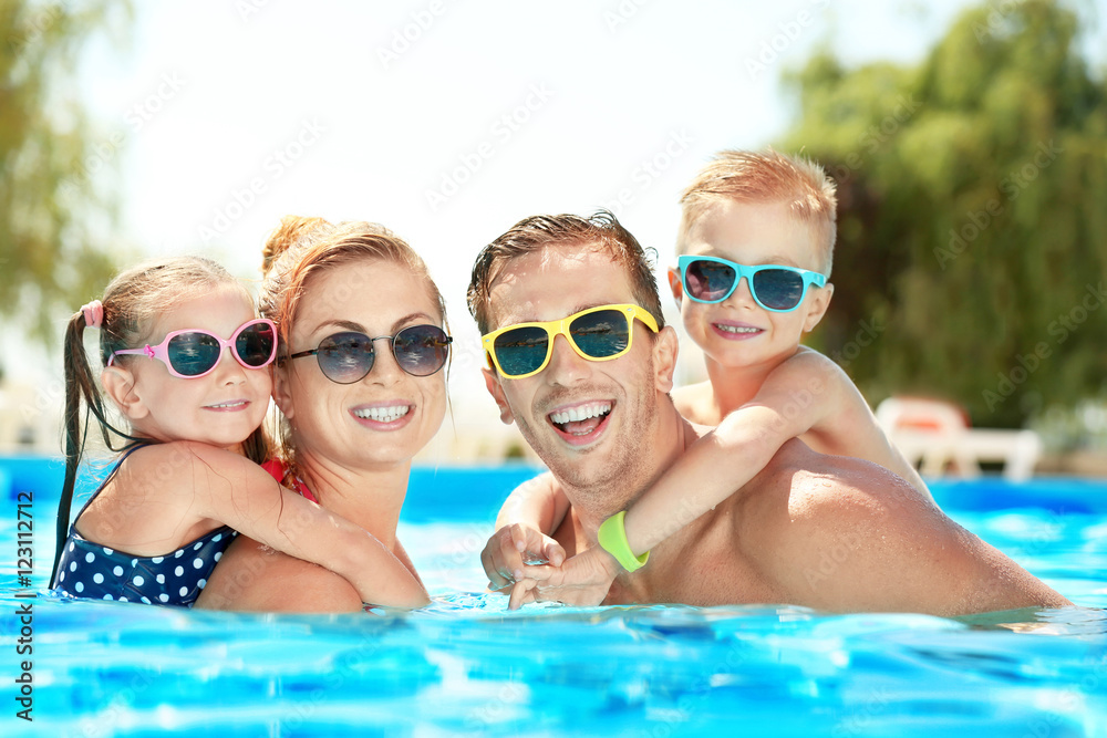 Happy family in swimming pool at water park Stock Photo | Adobe Stock