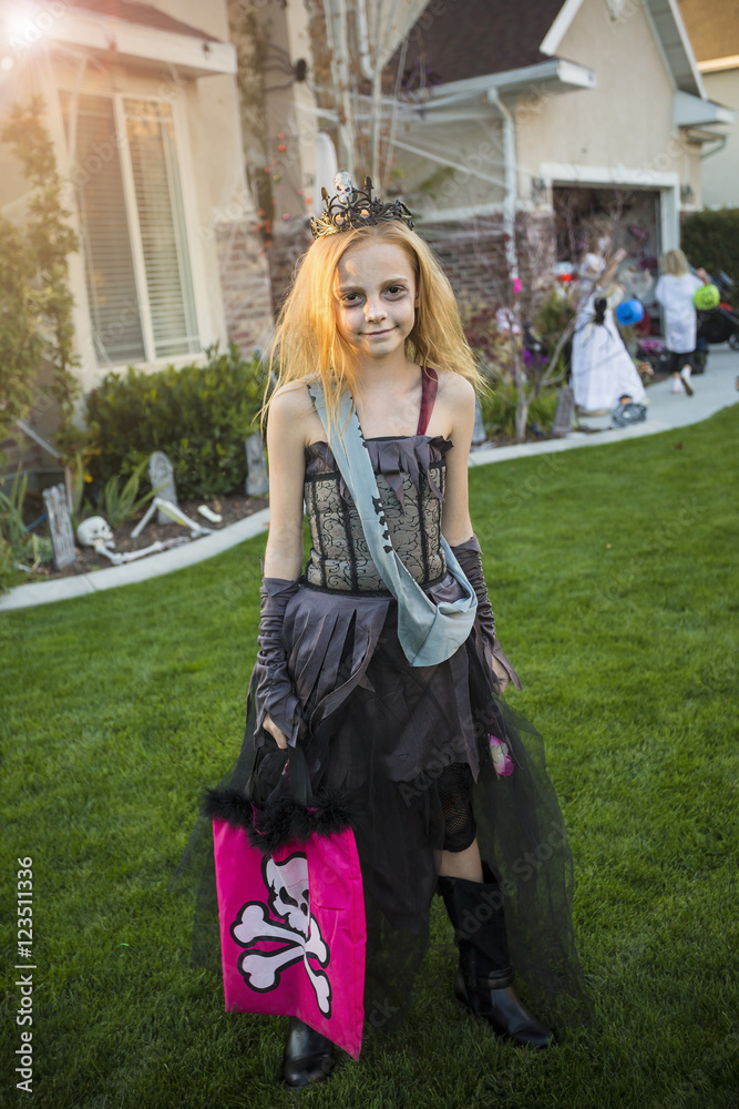 Little girl going trick or treating on Halloween in her costume Stock ...