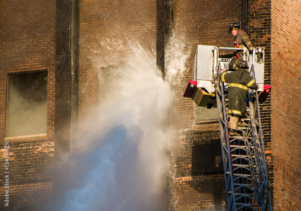 Firefighters spraying water into burning building downtown Chicago ...