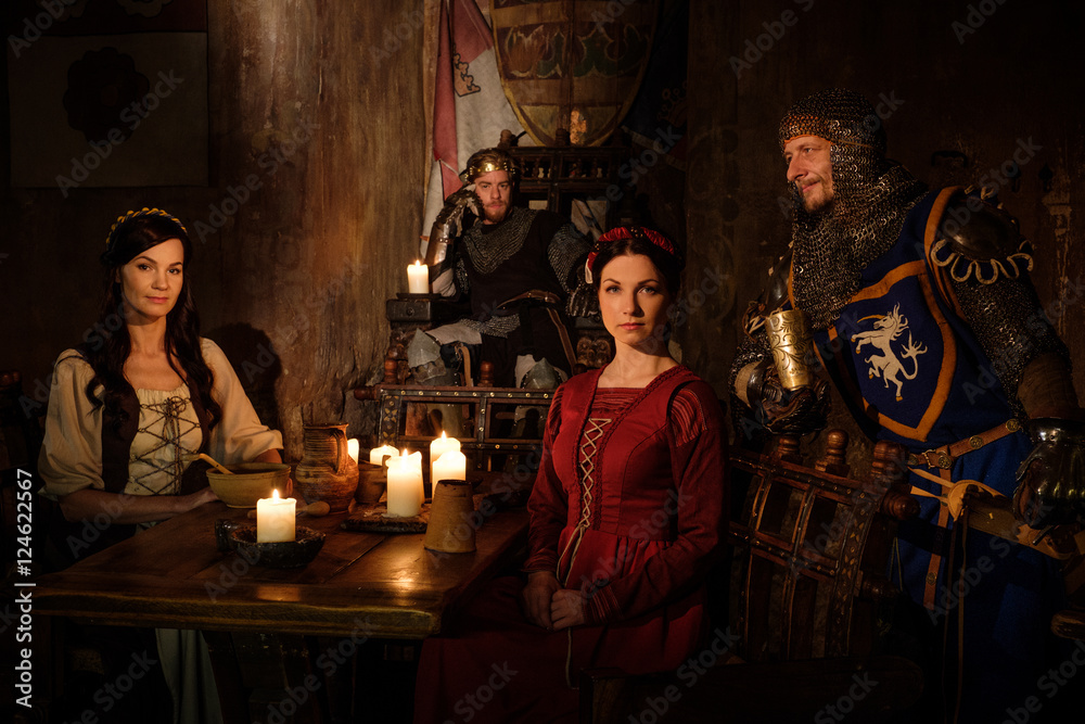 Medieval king and his subjects communicate in the hall of the castle ...