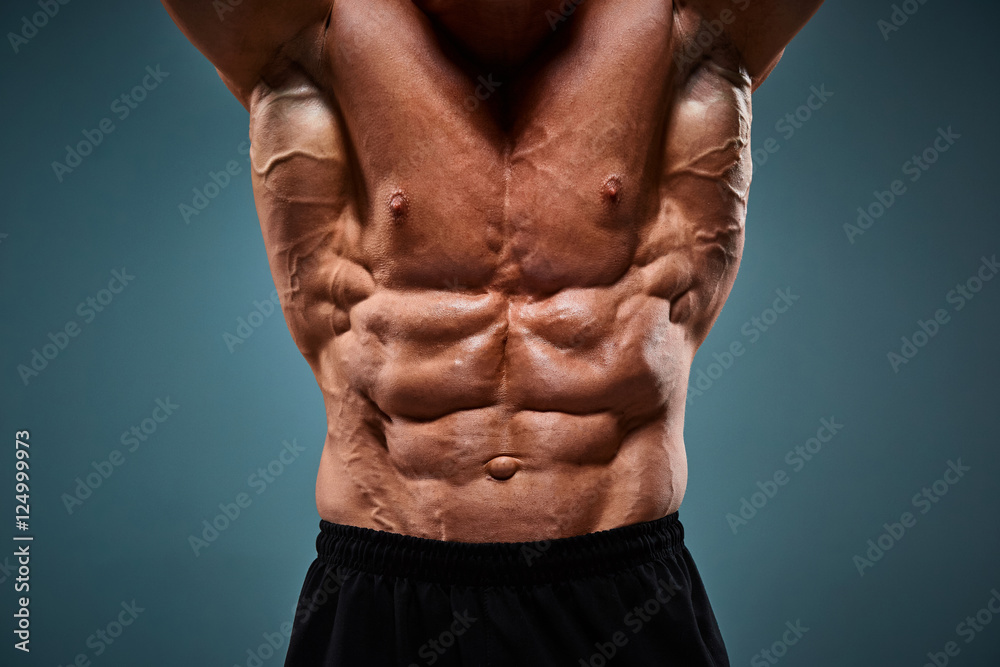 torso of attractive male body builder on gray background. Stock Photo ...