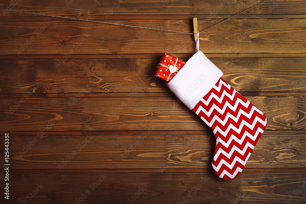 Christmas stocking hanging against wooden wall Stock Photo | Adobe Stock