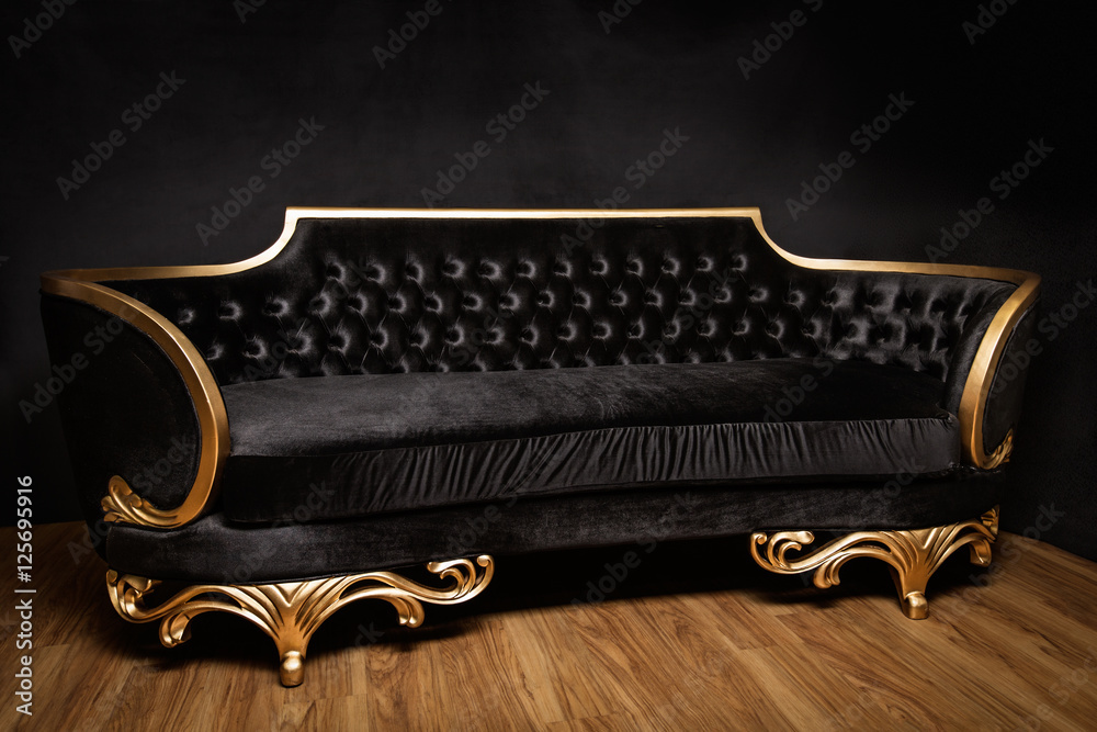 Stock Foto Big black and gold sofa Adobe Stock